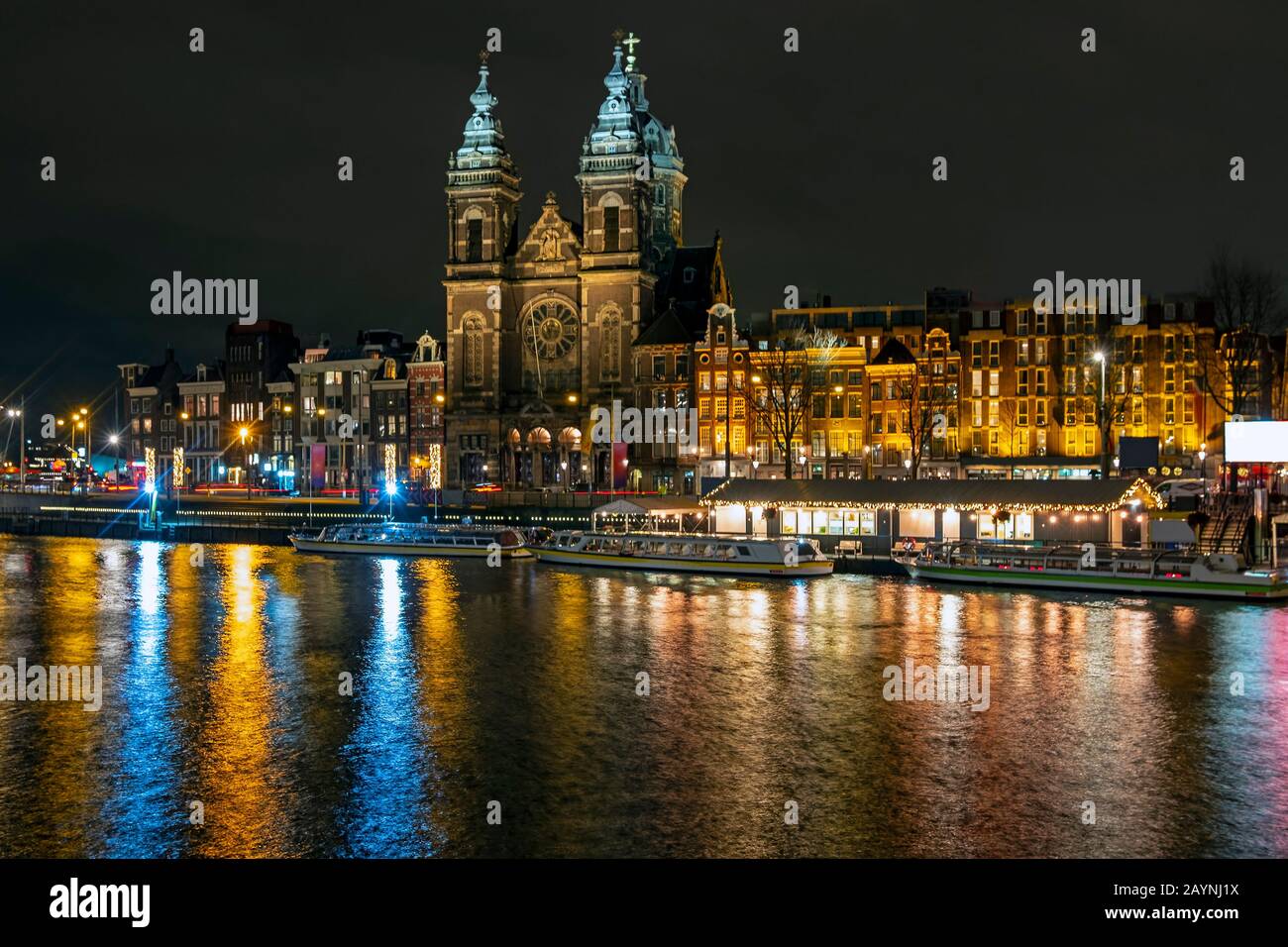 City scenic from Amsterdam in the Netherlands at night with the St ...