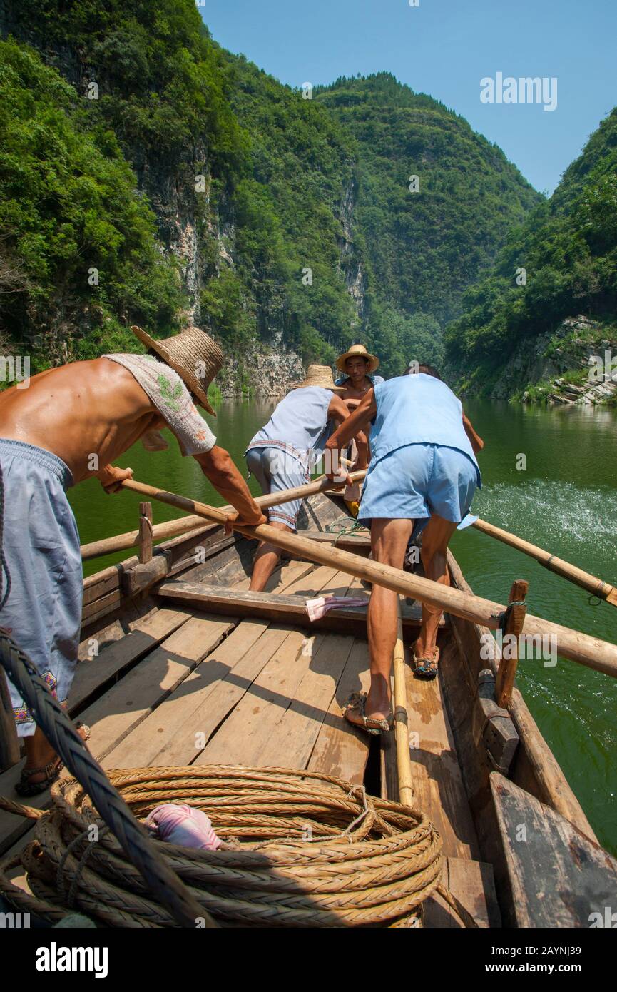 Chinese men rowing a traditional Sampan boat near Badong on the ...
