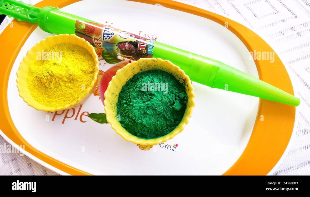 A STILL LIFE OF A Plastic (PICHKARI) WATER GUN AND COLOURS USED IN THE ...