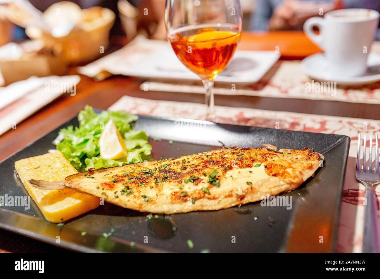 Fresh fish on a plate in restaurant Stock Photo - Alamy