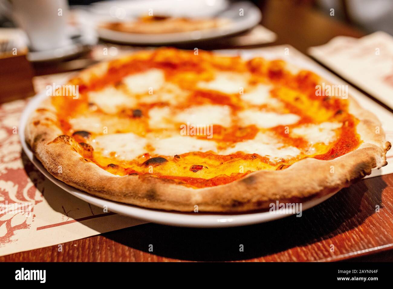 pizza on a plate in restaurant Stock Photo - Alamy