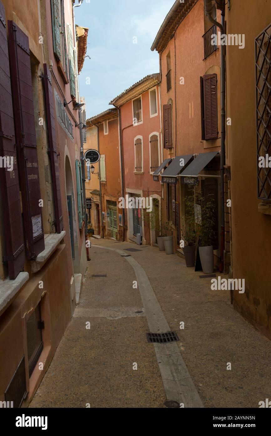 A cobblestone street in the village of Roussillon in the Luberon ...