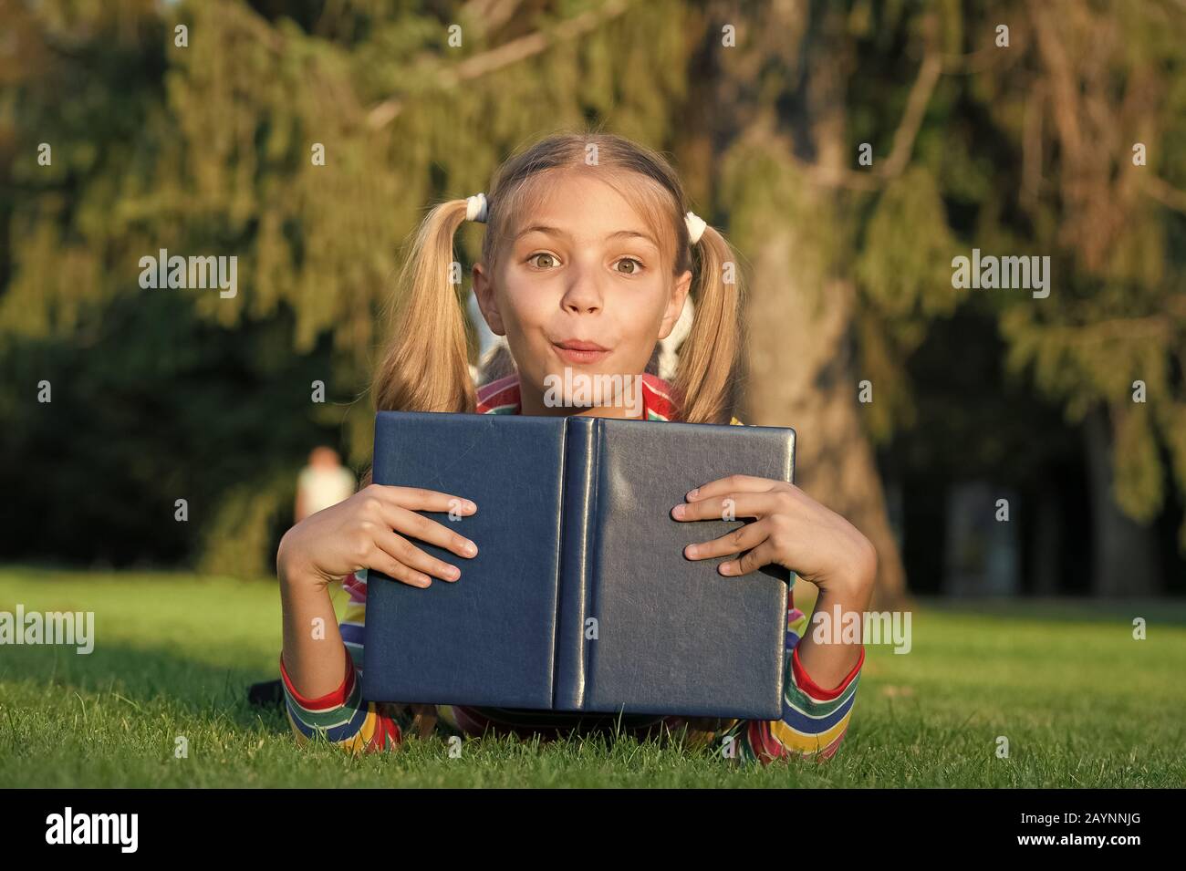 Study with pleasure. Time for great stories. Little child reading book ...