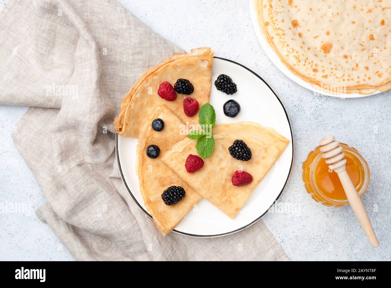 French Crepes With Summer Berries And Honey On Plate. Table Top View ...