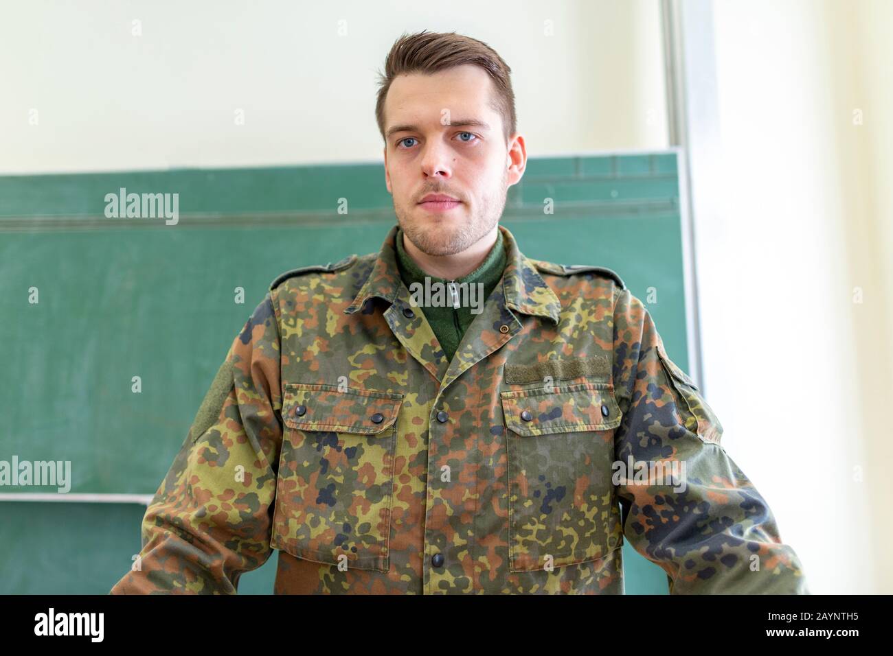German soldier stands in a classroom . German word Bundeswehr, means ...