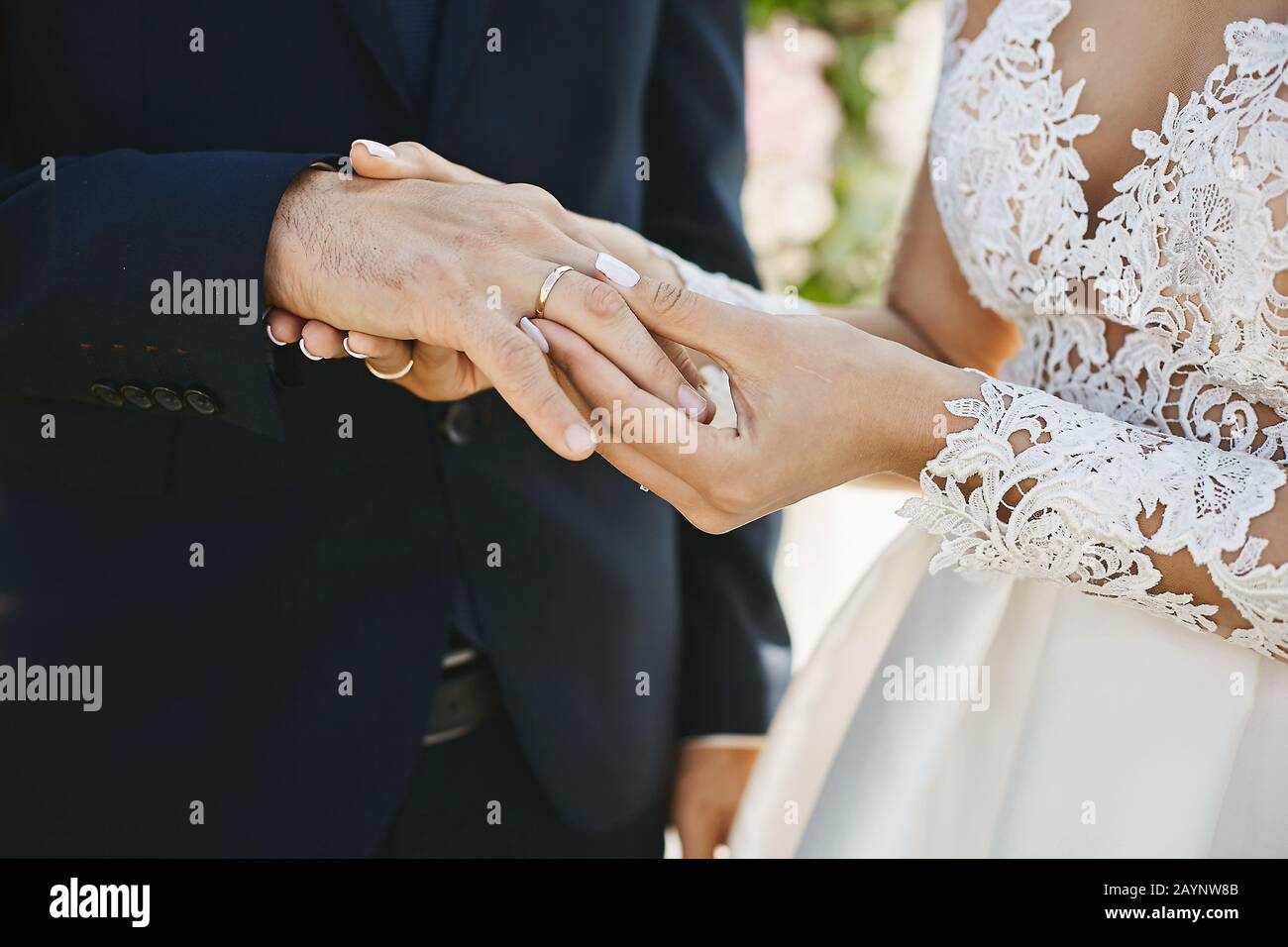 Husband wife putting wedding rings hi-res stock photography and images ...