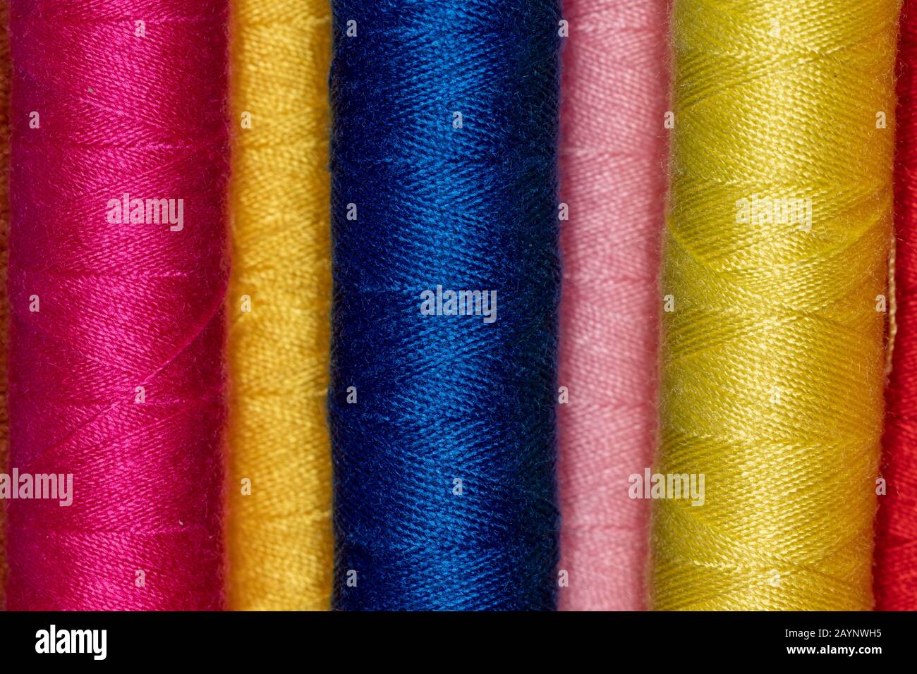 Vertical cones with colored sewing thread Stock Photo - Alamy