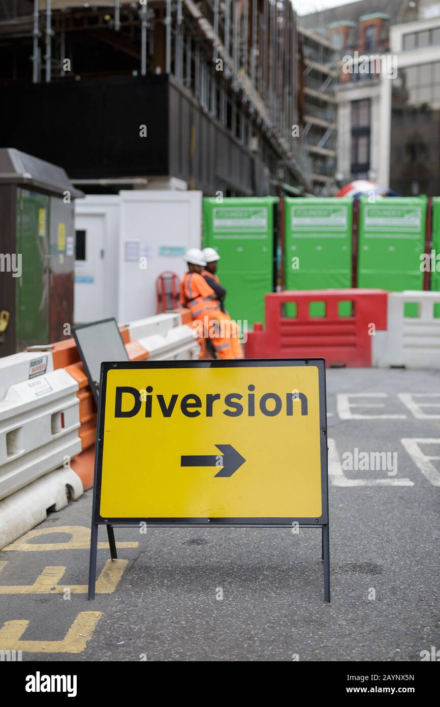 Yellow Road Sign with Arrow, Diversion: Barrier and Workers in ...
