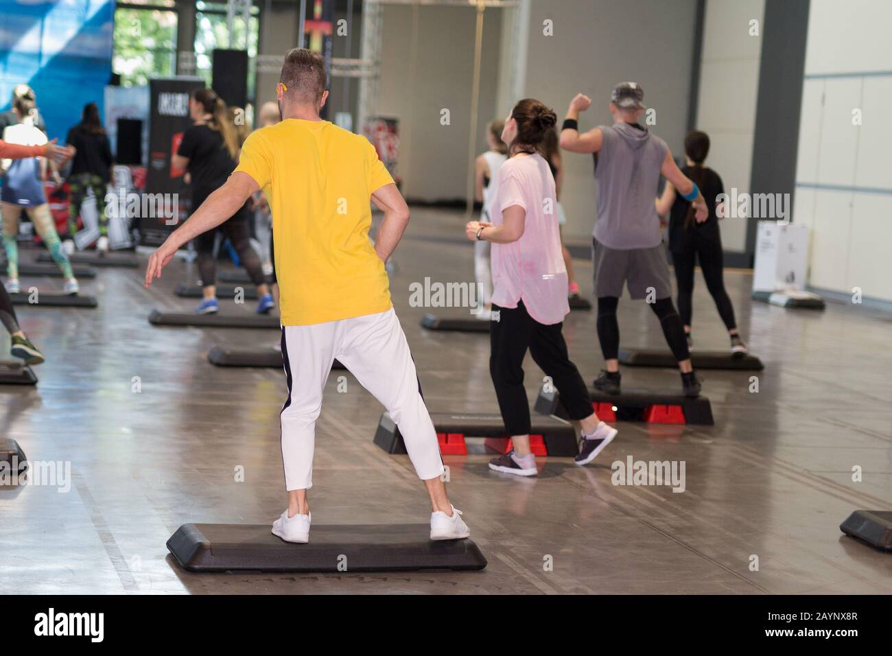 Fitness Workout in Gym: People doing Exercises in Class with Step ...