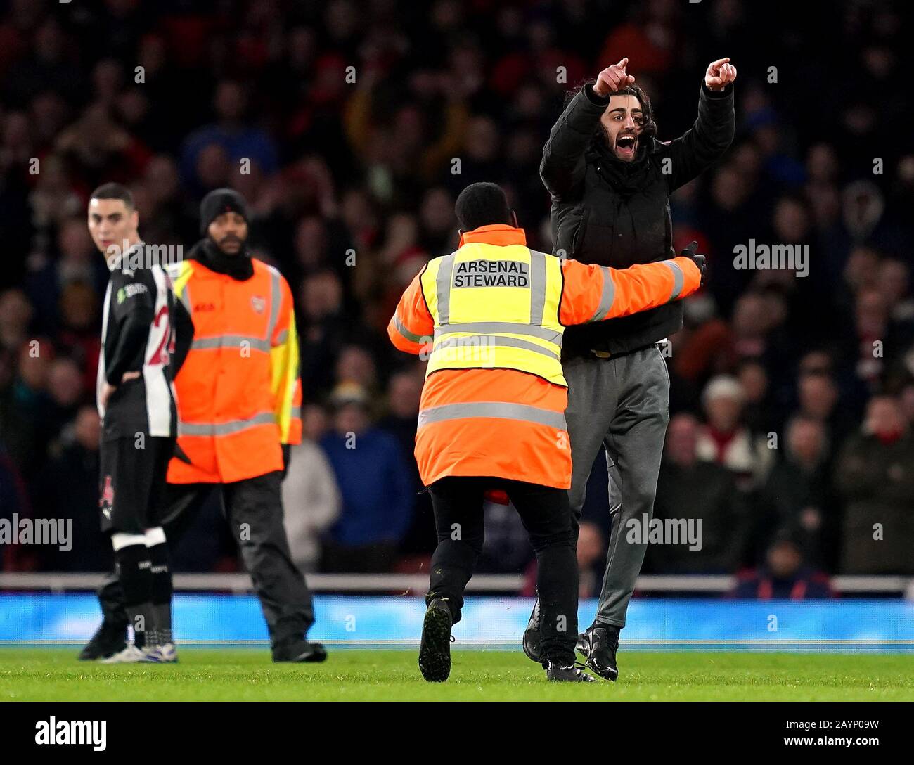 A pitch invader is restraint by ground stewards during the Premier ...