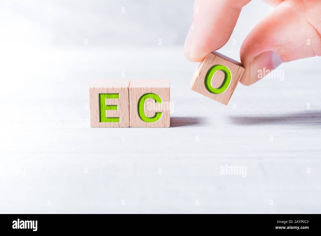Word Eco Formed By Wooden Blocks And Arranged By A Male Hand On A White ...