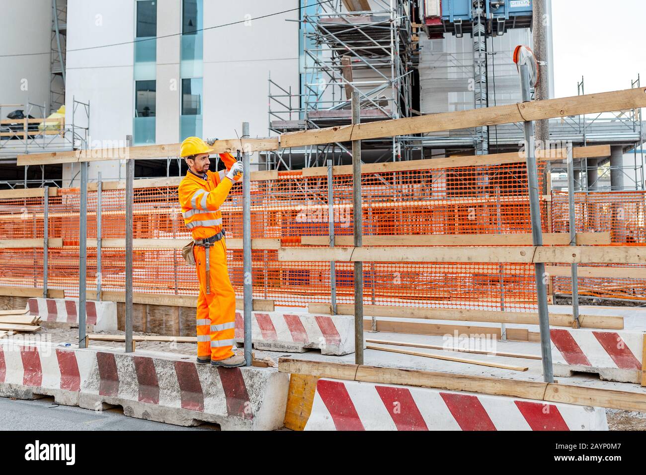 23 OCTOBER 2018, VENICE, ITALY: Construction worker in orange safety ...