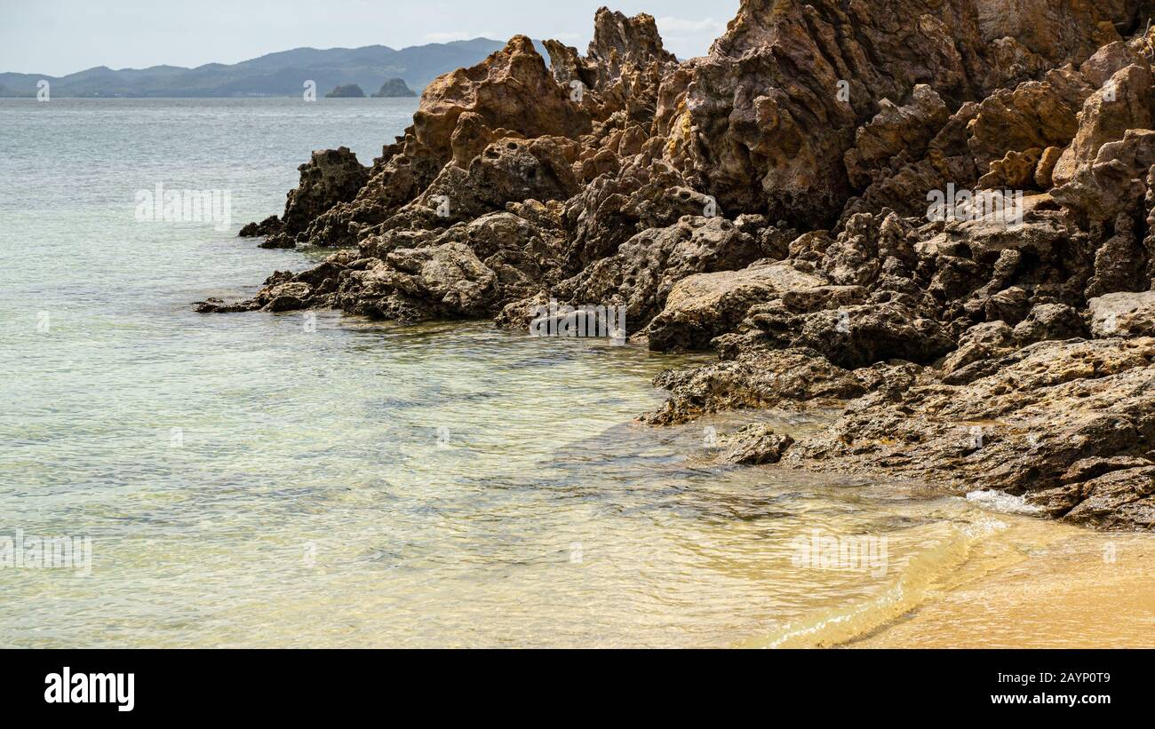 Clean water being on the rocky shore Stock Photo - Alamy