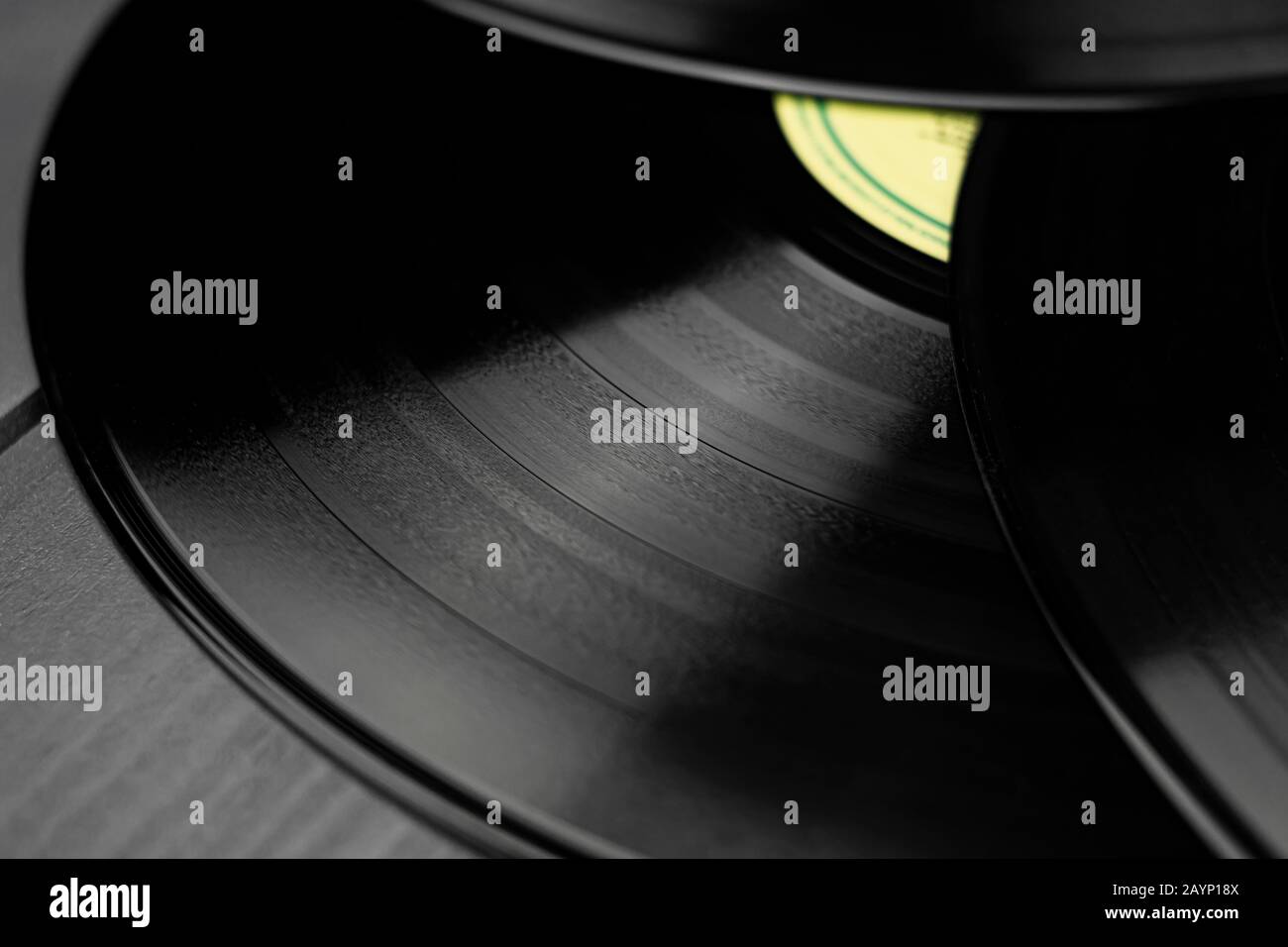 Stacked glossy vinyl records on which tracks of songs can be displayed ...
