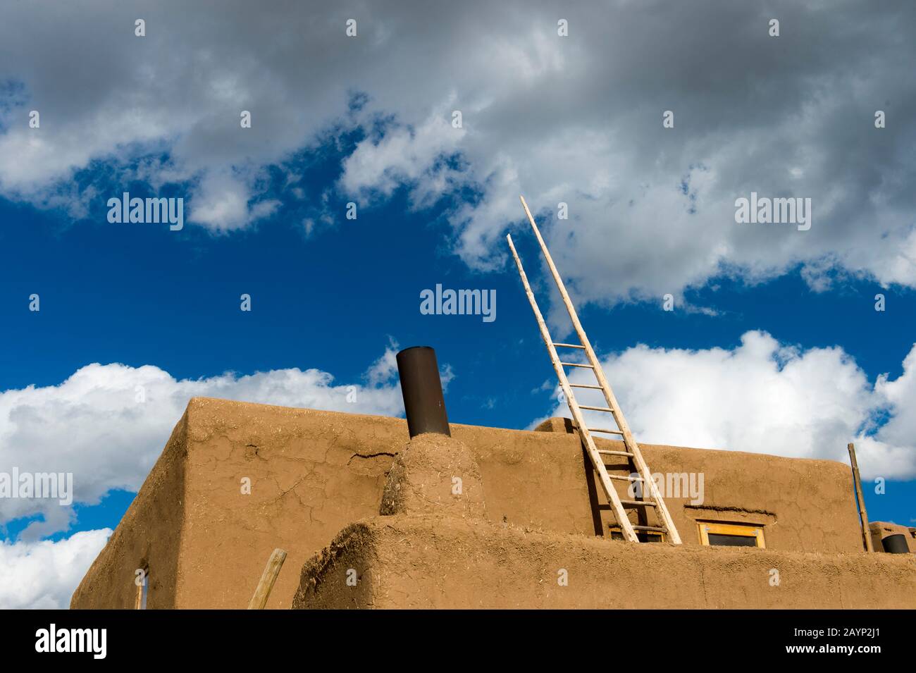 Ladders being used to move to different levels of the Taos Pueblo which ...