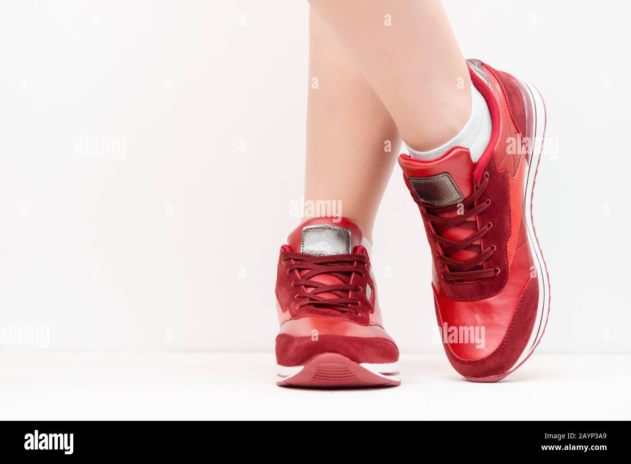 Red sport shoes on female legs close up background. Front view Stock ...