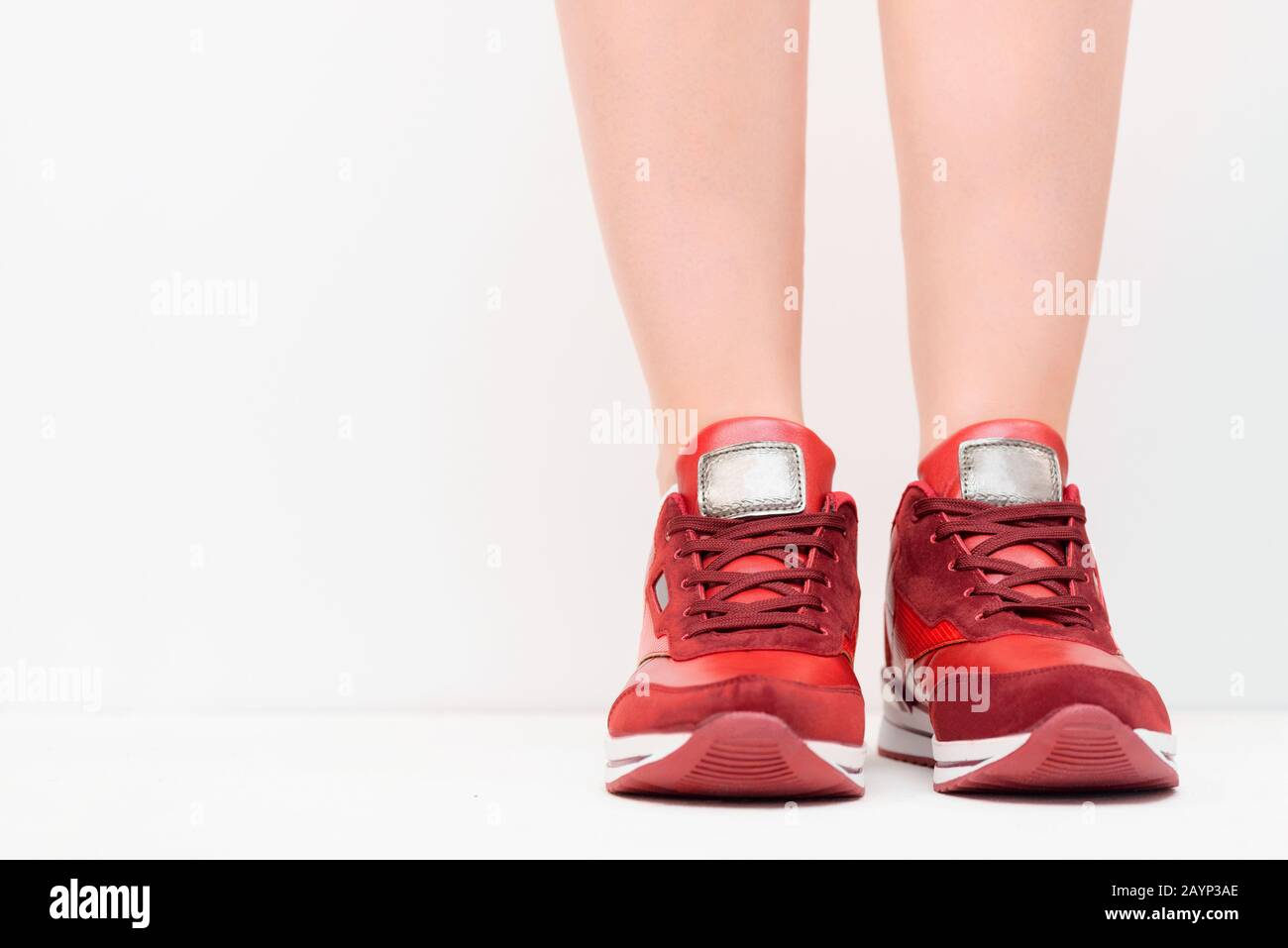 Red sport shoes on female legs close up background. Front view Stock ...