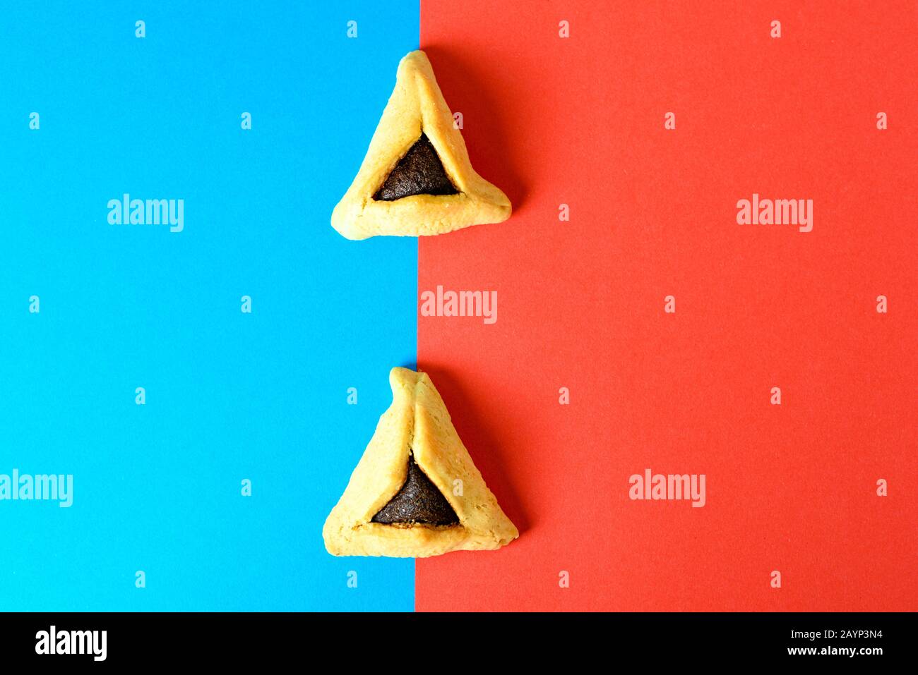 Purim holiday concept. Creative arrangement of Hamantash on red and ...