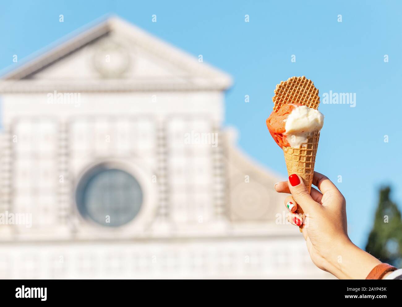 Young happy asian tourist woman eating ice-cream in front of the Croce ...