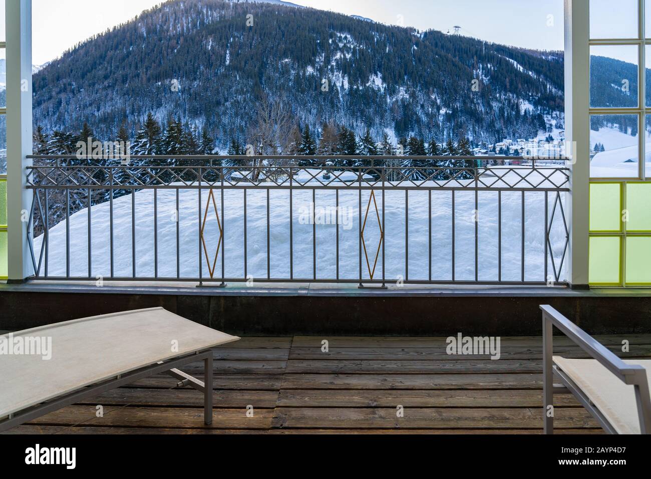 Relaxing chair on a balcony with view over mountain range of Davos on ...