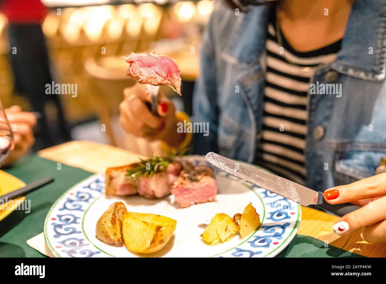 Woman eating delicious rare beef steak in restaurant Stock Photo - Alamy