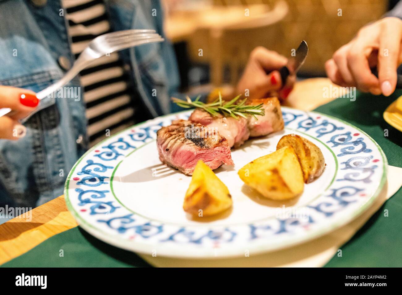 Woman eating delicious rare beef steak in restaurant Stock Photo - Alamy