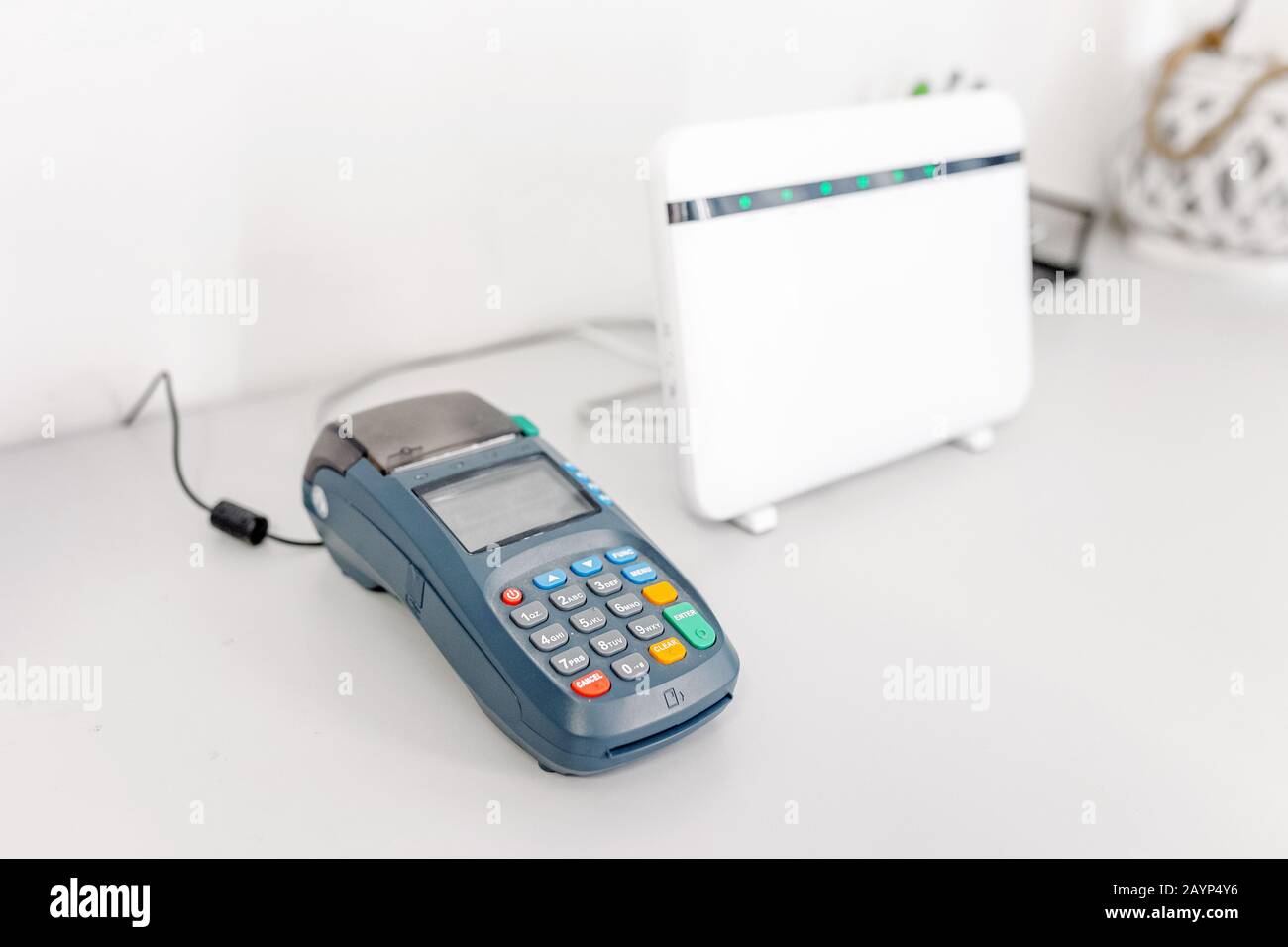 Pos terminal and wireless network router in office Stock Photo - Alamy