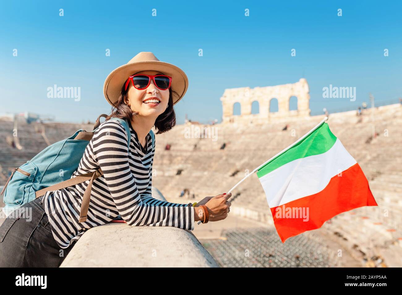 happy young asian woman with italian flag in front of the famous ...