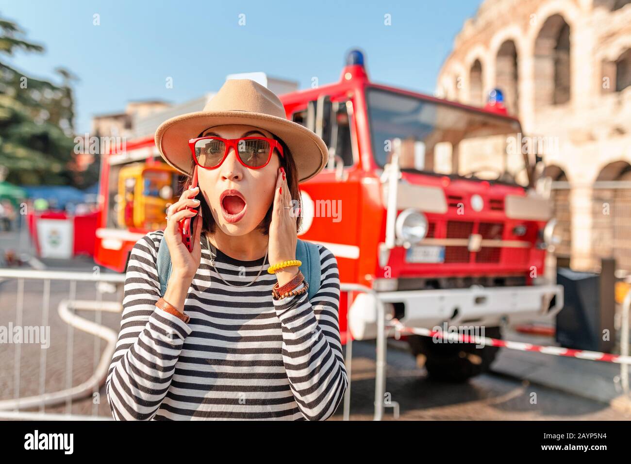 woman with a smartphone dialing emergency 911 or 112 number on screen ...