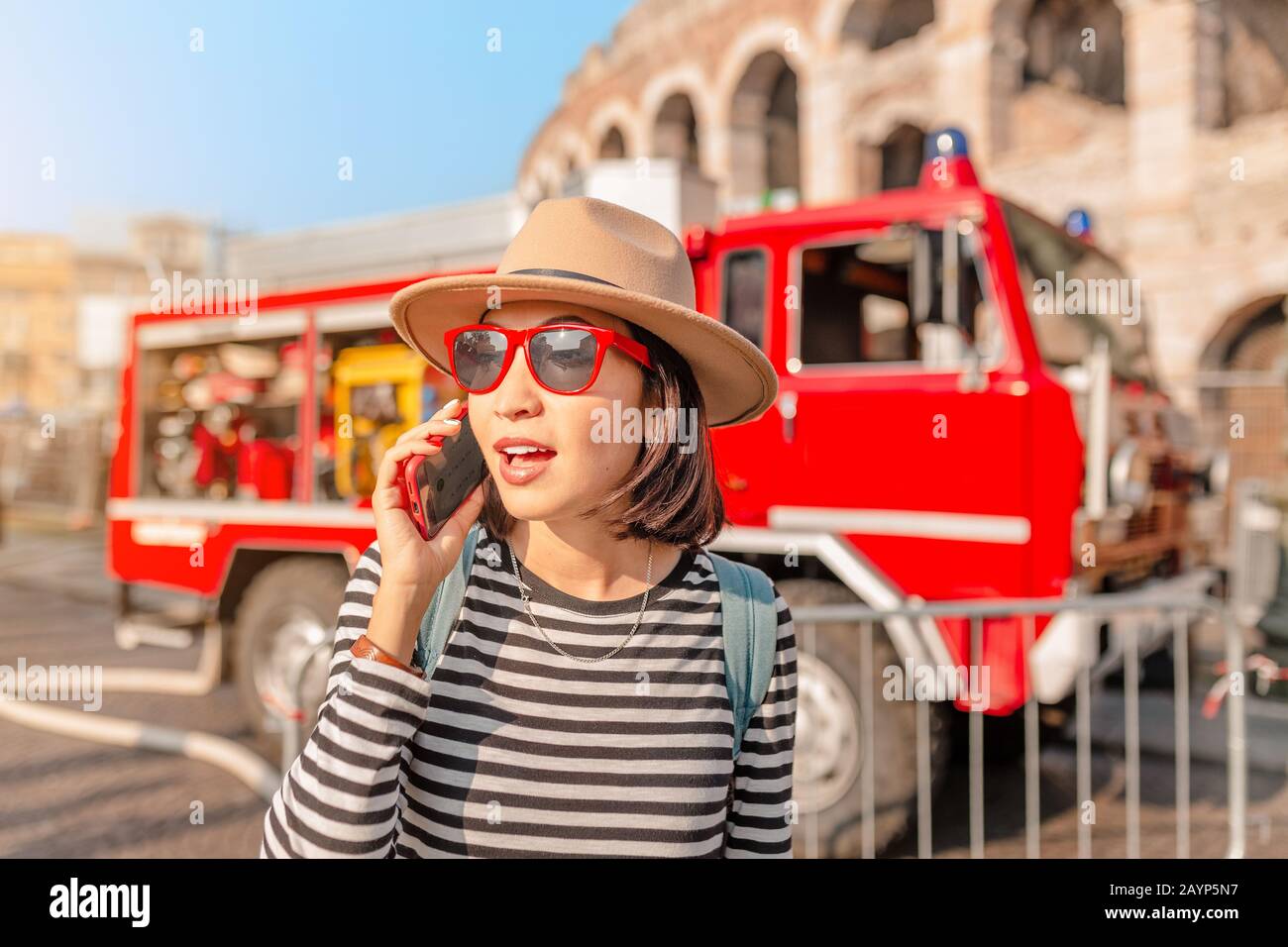 woman with a smartphone dialing emergency 911 or 112 number on screen ...