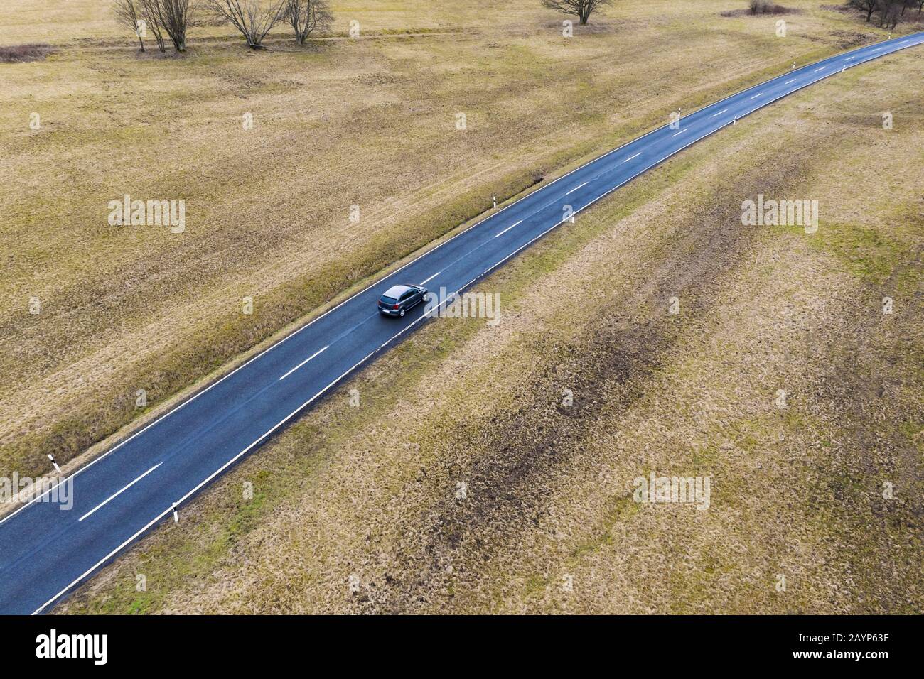 a straight street with a car driving from above Stock Photo - Alamy
