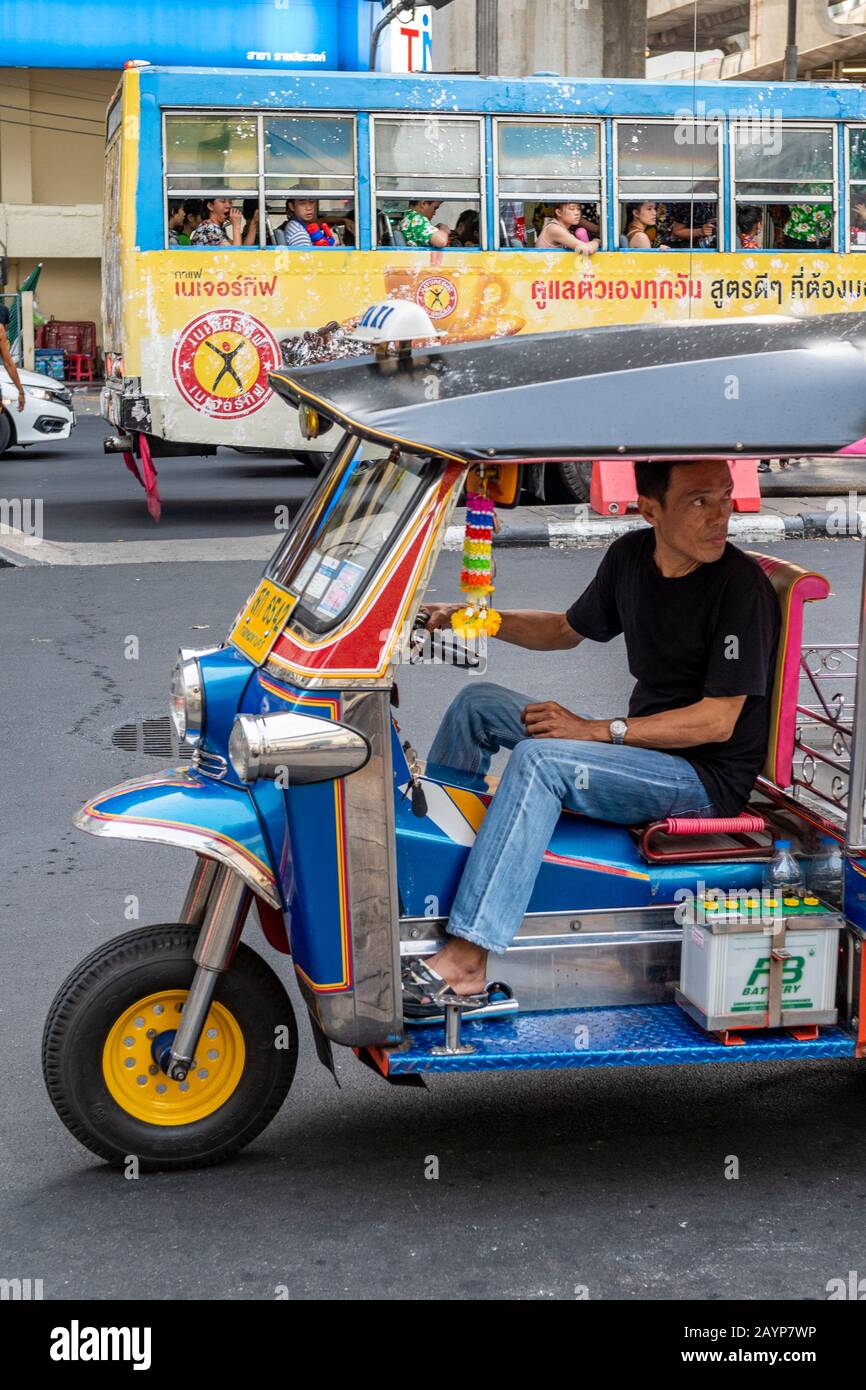 a typical colourful tuk-tuk driver in the centre of Bangkok in Thailand ...