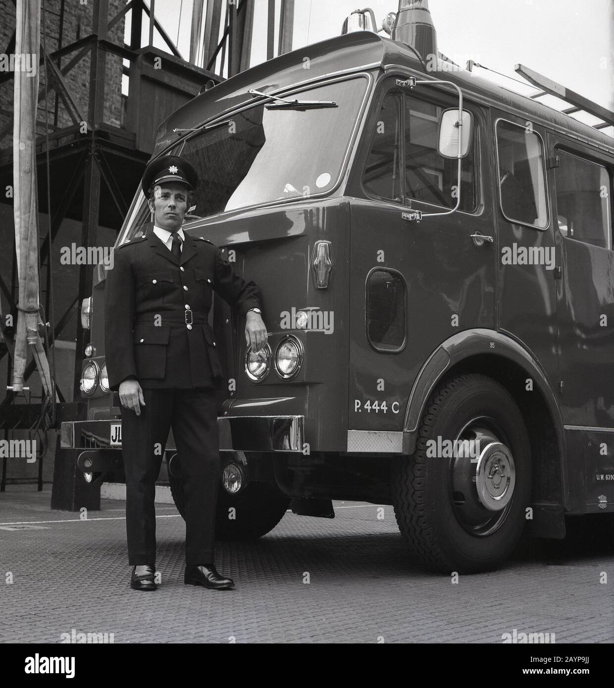 1960s, historical, a proud uniformed fireman standing by the front of ...