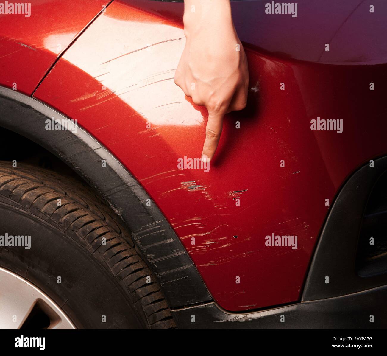 Hand point at scratches on bumper of red modern car Stock Photo - Alamy