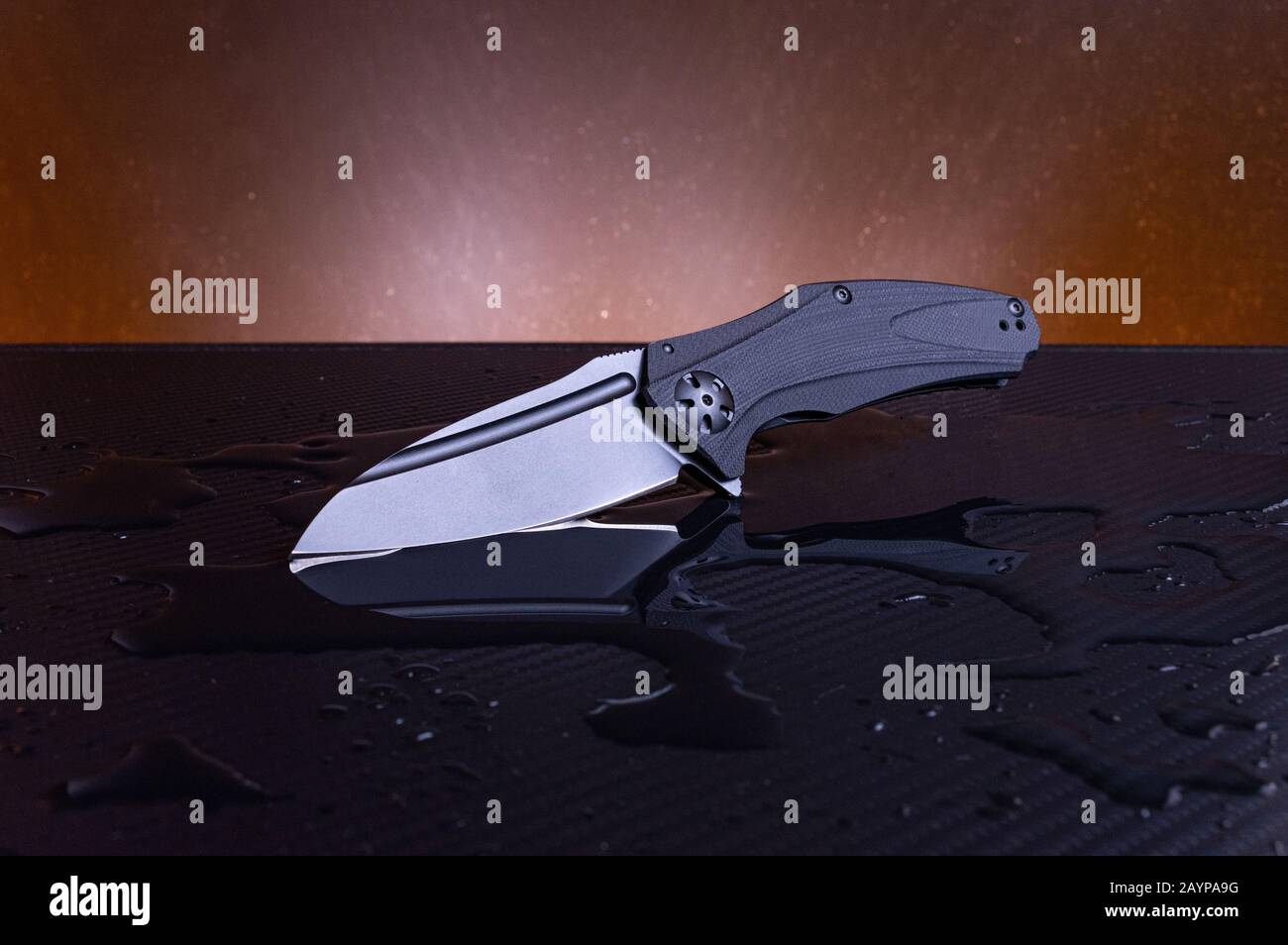 Black folding knife. Pocket knife and water. Front view Stock Photo - Alamy