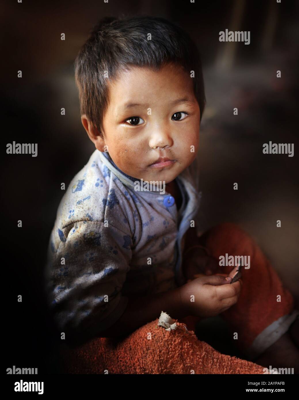 A child eating a biscuit- Chin State- Mindat -Myanmar Stock Photo - Alamy