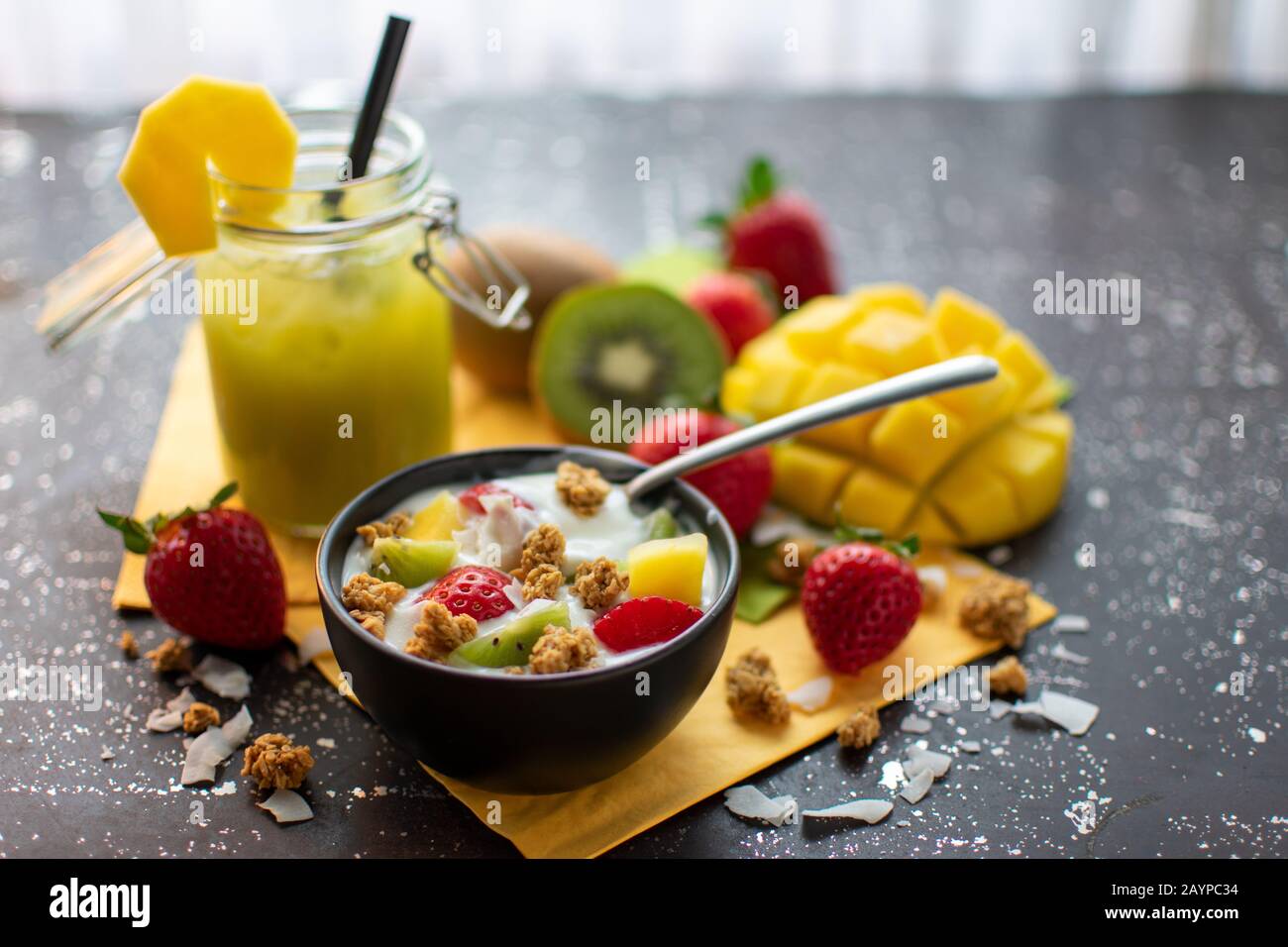healthy breakfast: crispy muesli with yoghurt fresh strawberries, kiwis ...