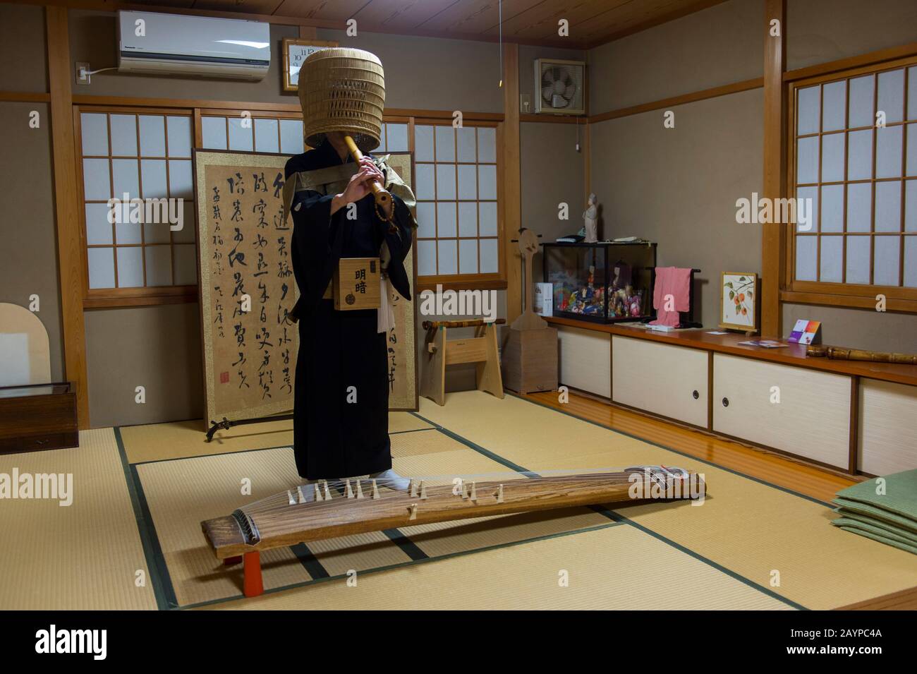 A Japanese man in traditional monks outfit in Kyoto, Japan, is playing ...
