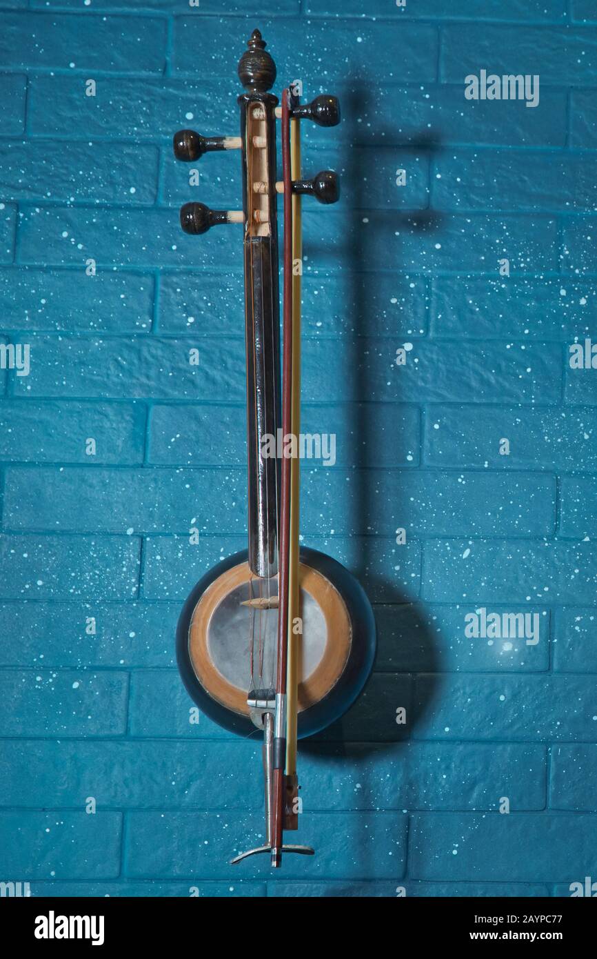 Tar in front of blue brick wall .Classical music concert poster with ...