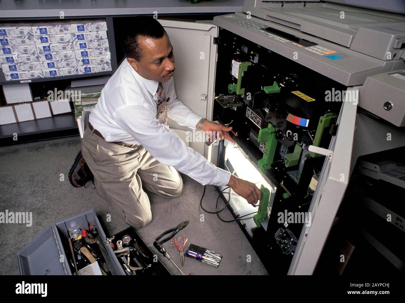 Austin Texas USA,1992: Male Hispanic technician repairs an office ...
