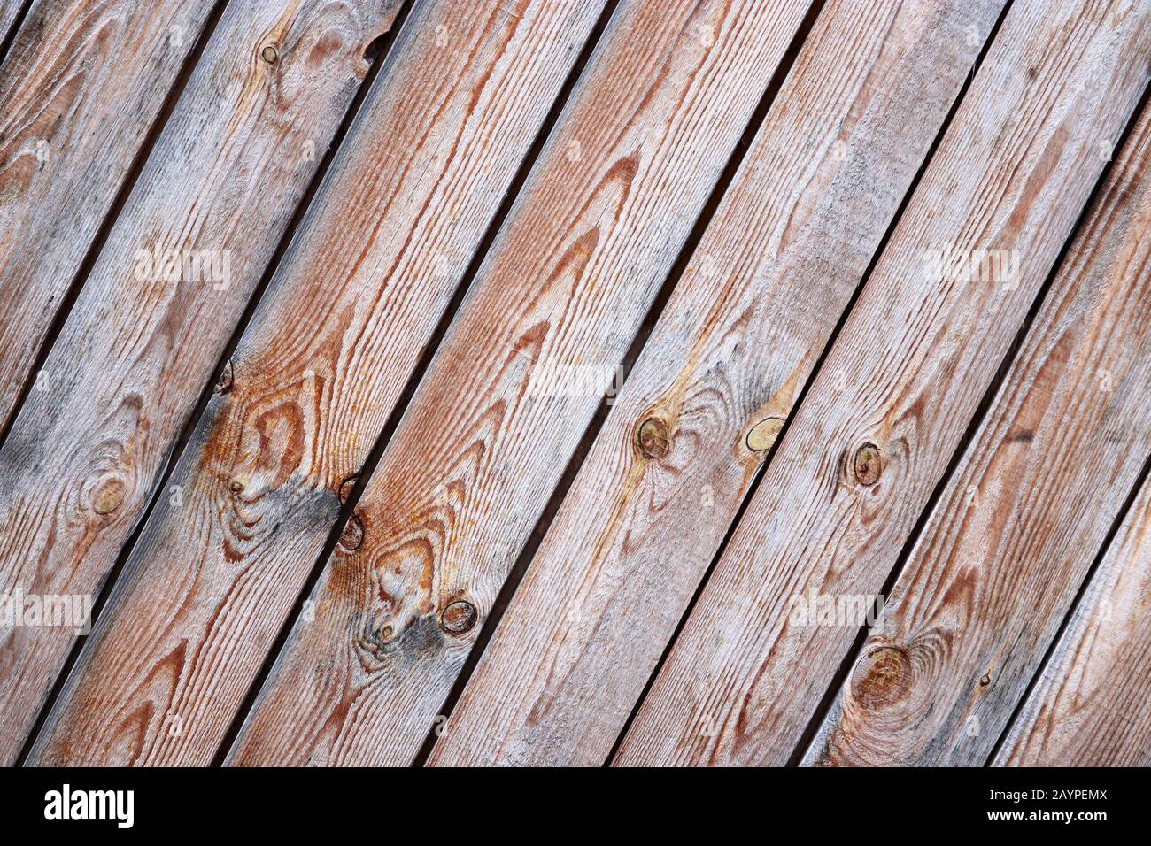 Wooden wall, unpainted brown boards. Diagonal old panels texture with ...