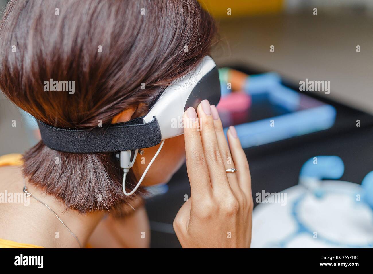 Woman with digital headwear equipment sensor connected to her ear ...