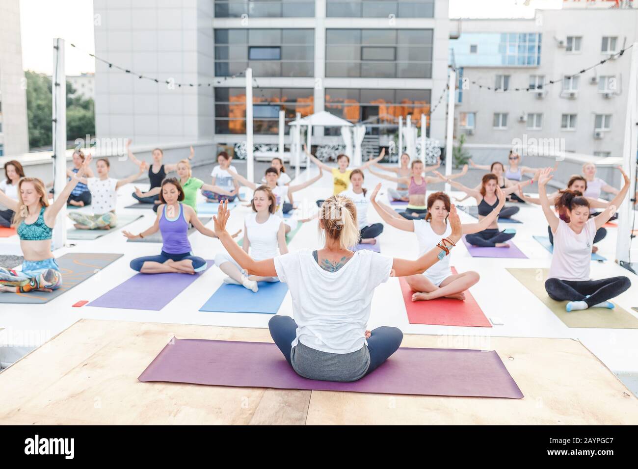 01 JULY 2018, UFA, RUSSIA: A group of people in poses asana doing yoga ...