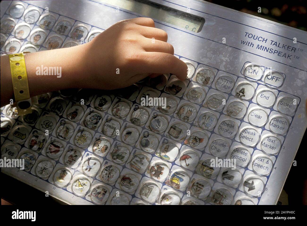 Disabled child uses Touch Talker communication device, developed by the ...