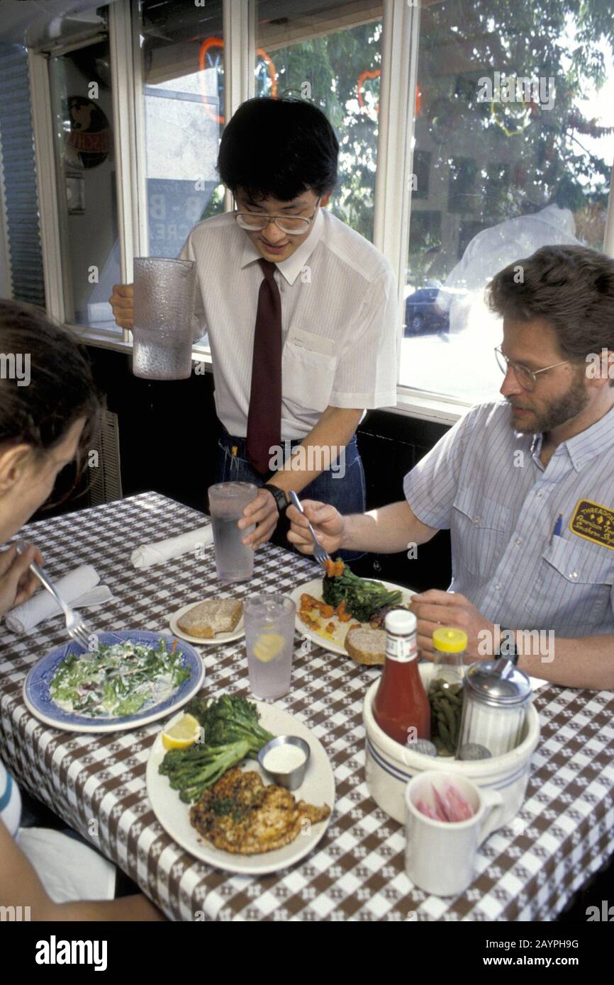 Austin, Texas: Asian-American teenage boy working as waiter in ...
