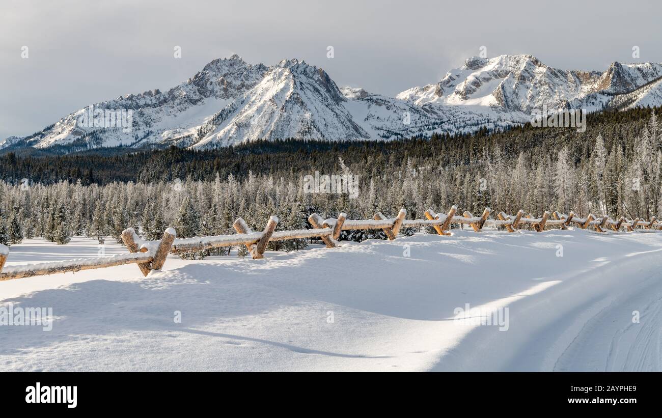 Sawtooth Mountains beyond winter snow and wood fence Stock Photo - Alamy