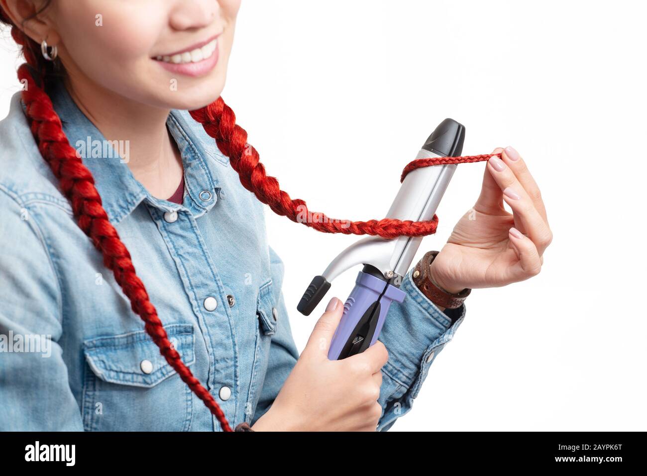 Woman uses professional Ironing tool to style her hair isolated on ...