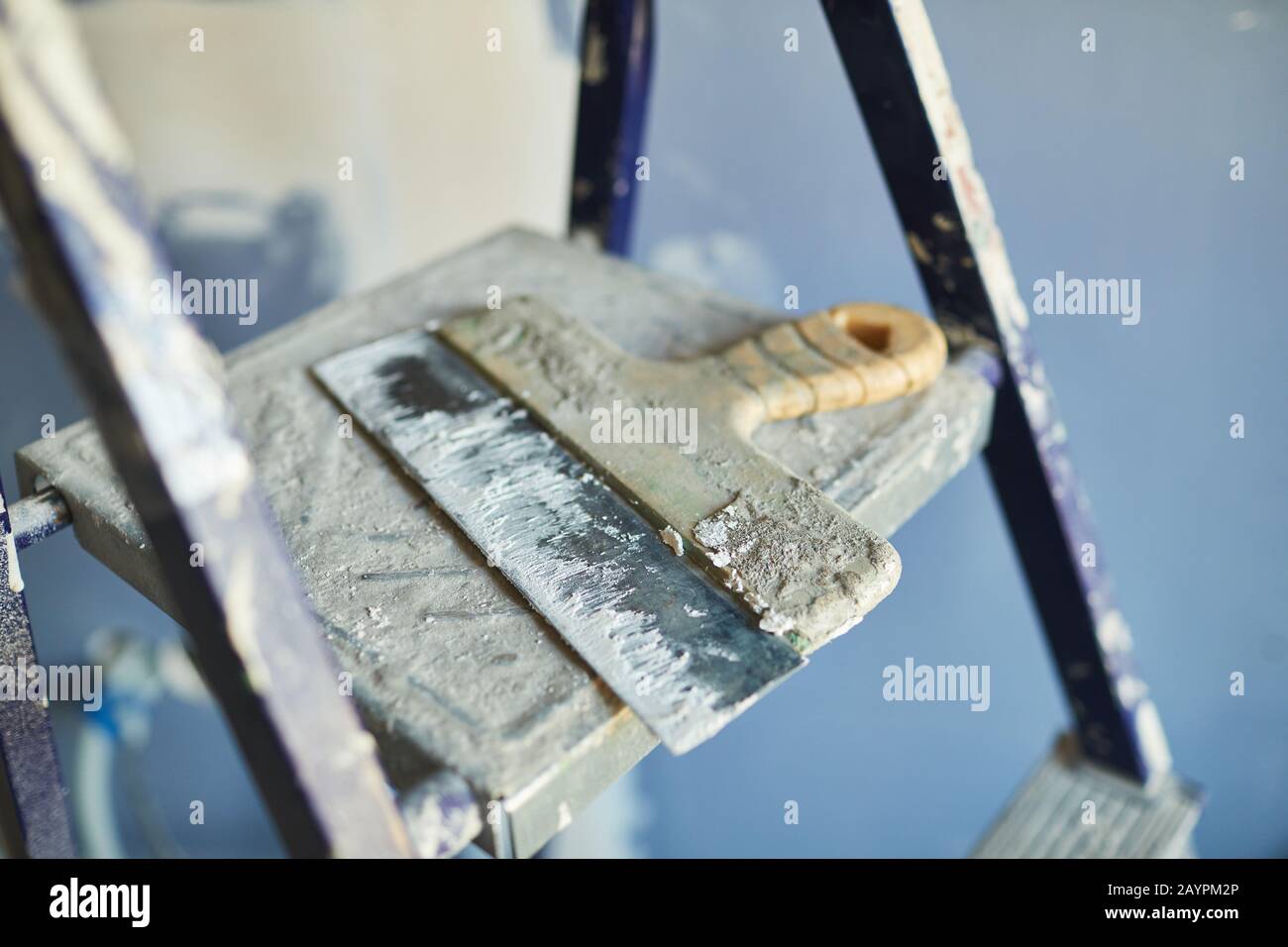 Background image close up of used spatula lying on top of ladder on ...