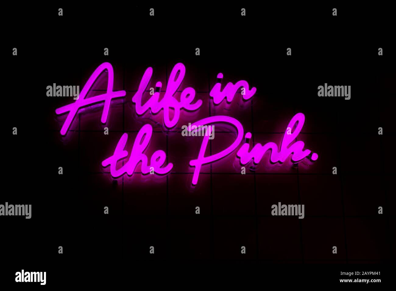 Pink Neon Sign With Text On Dark Background Stock Photo - Alamy