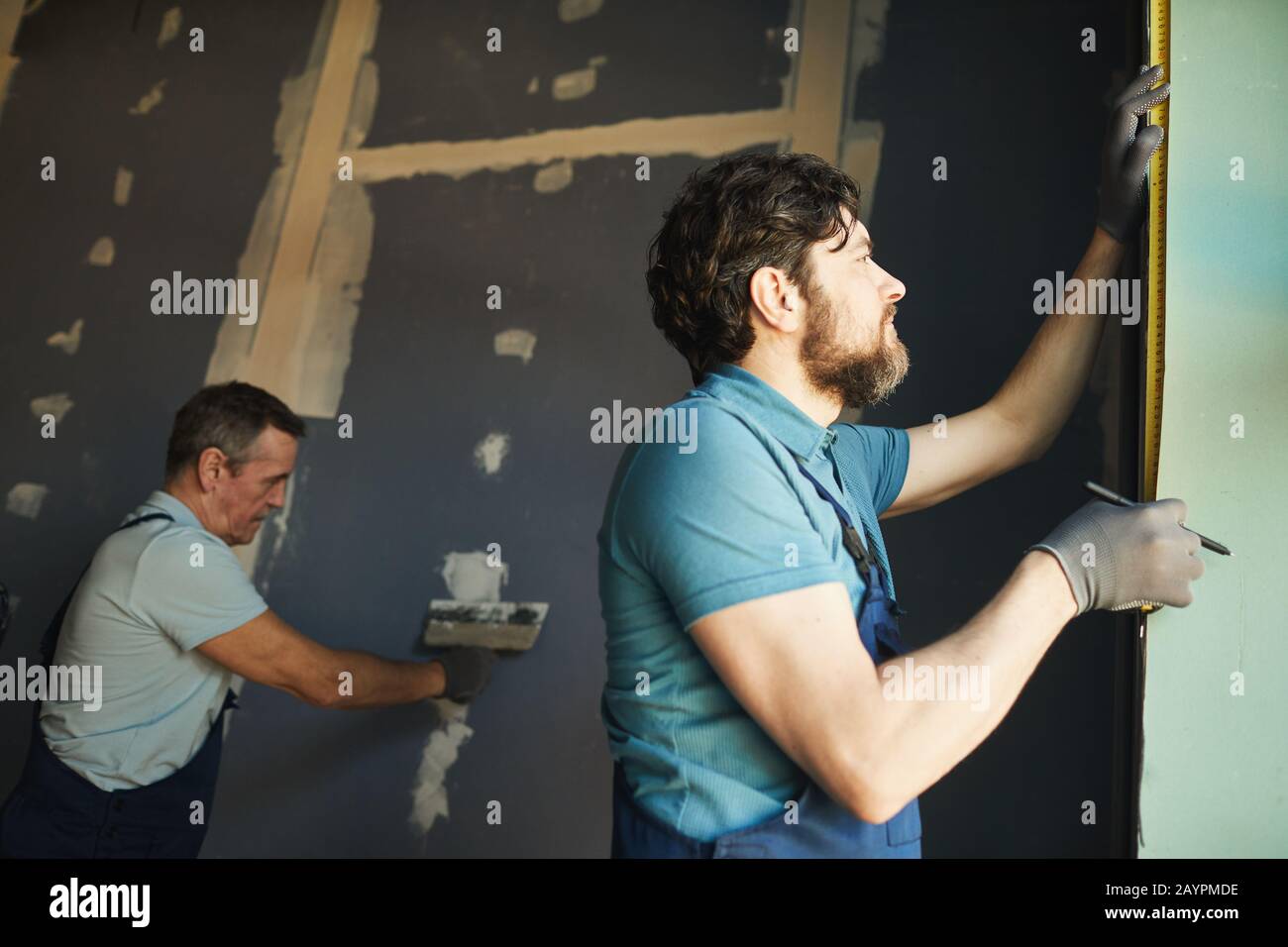 Low angle view of construction crew working in room while building or renovating house, copy ...